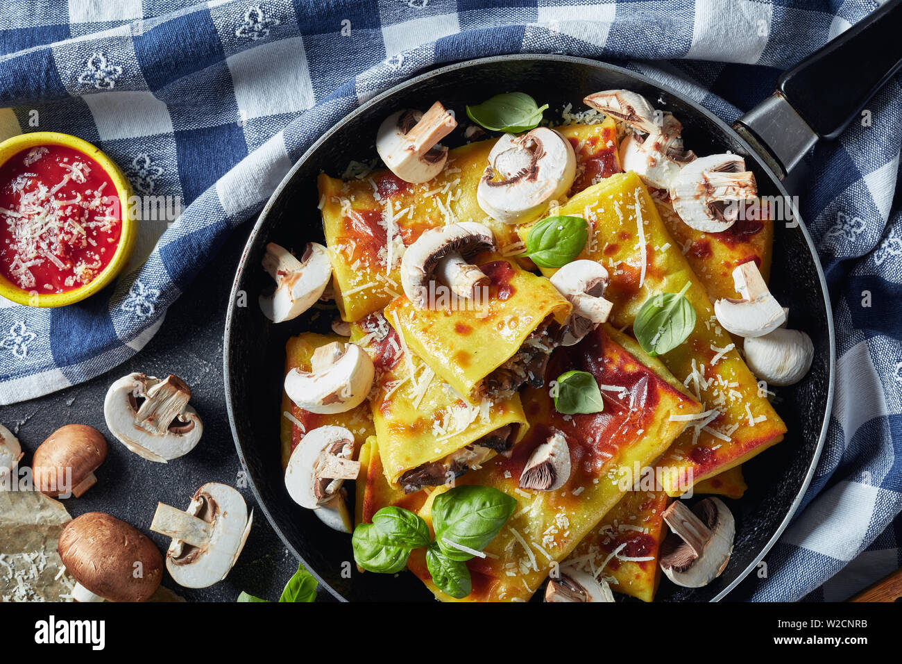 overhead view of Crepes with parmesan and mushrooms filling on a ...