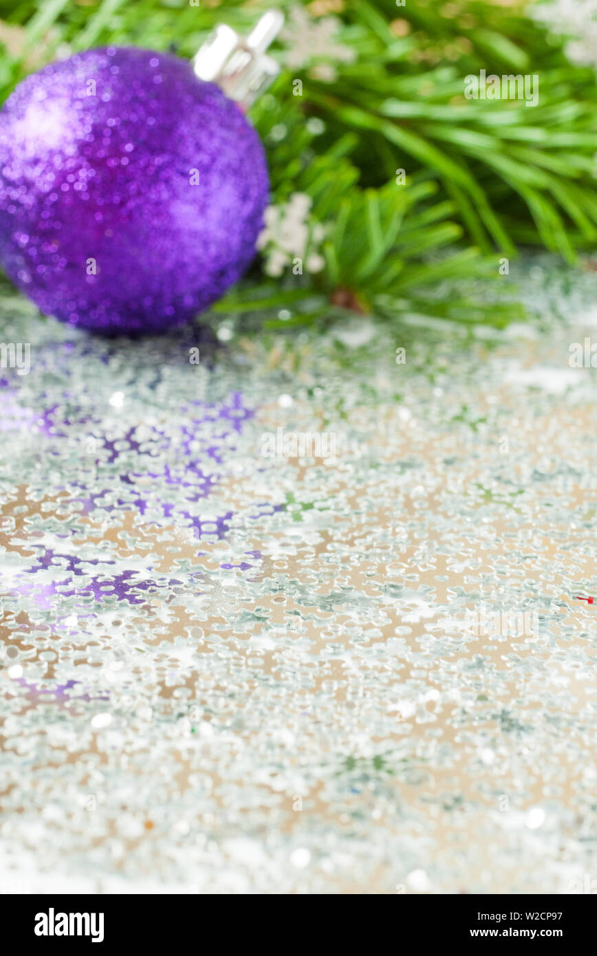 fir tree branch and Christmas toys bauble and snow flares confetti with ...