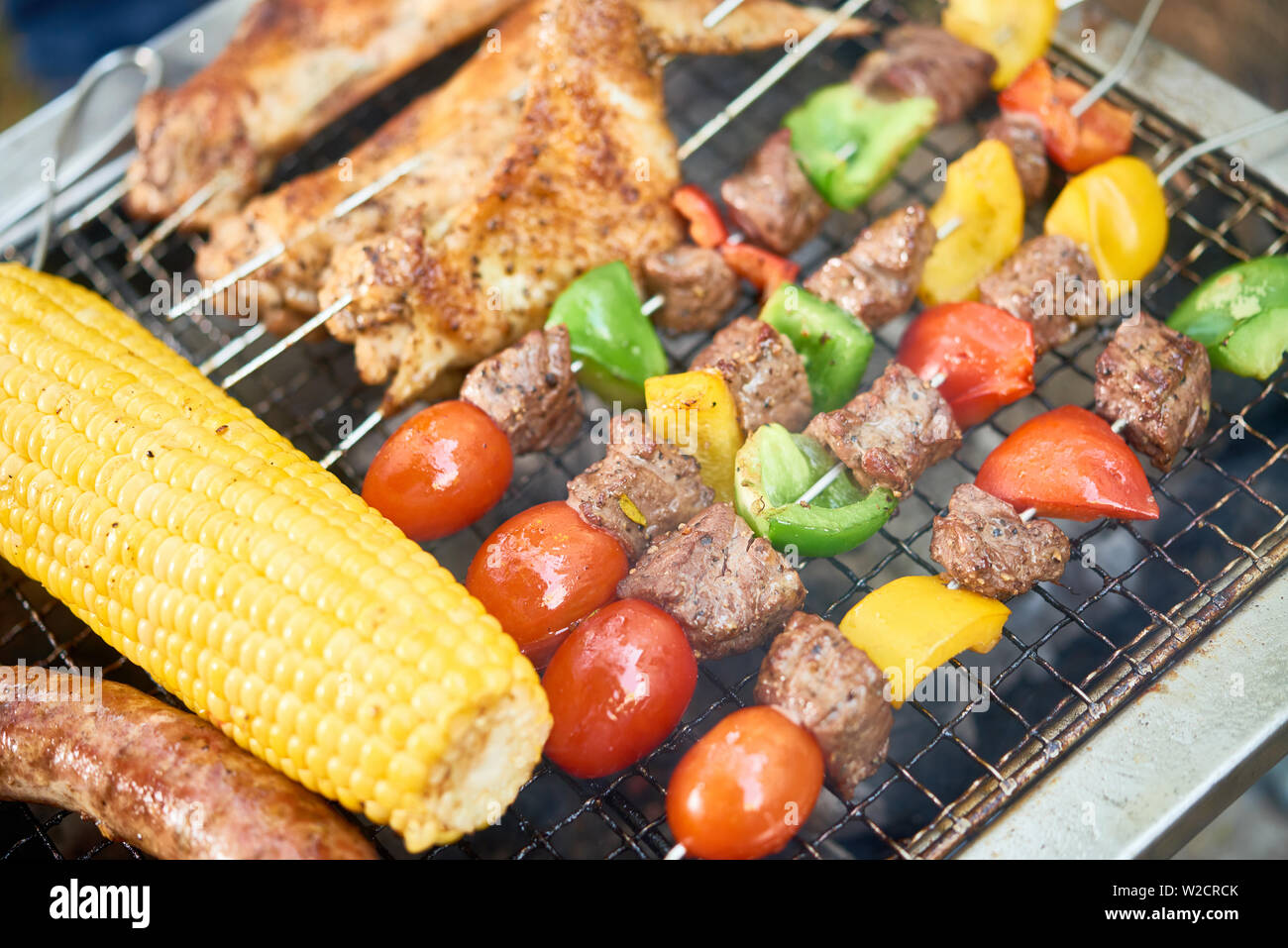 Close-up of kebabs of meat and vegetables cooked on grill outdoors ...