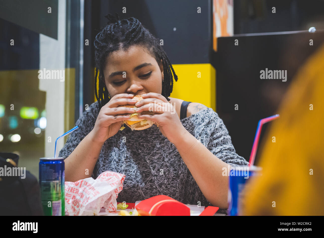 young african woman eating in fast food – appetite, break, relax Stock ...