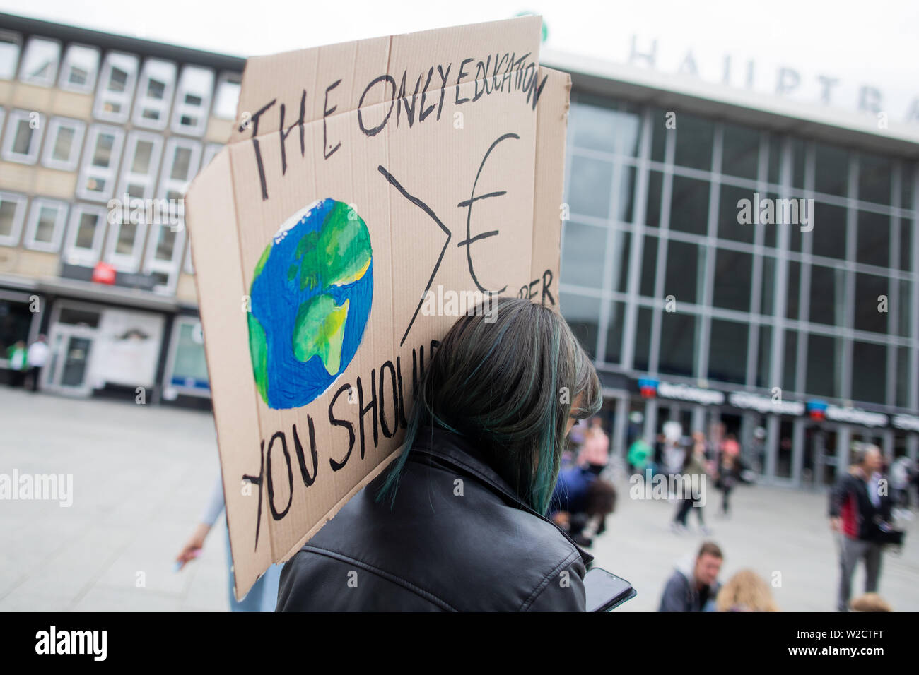 Cologne, Germany. 08th July, 2019. A student participates with a poster ...