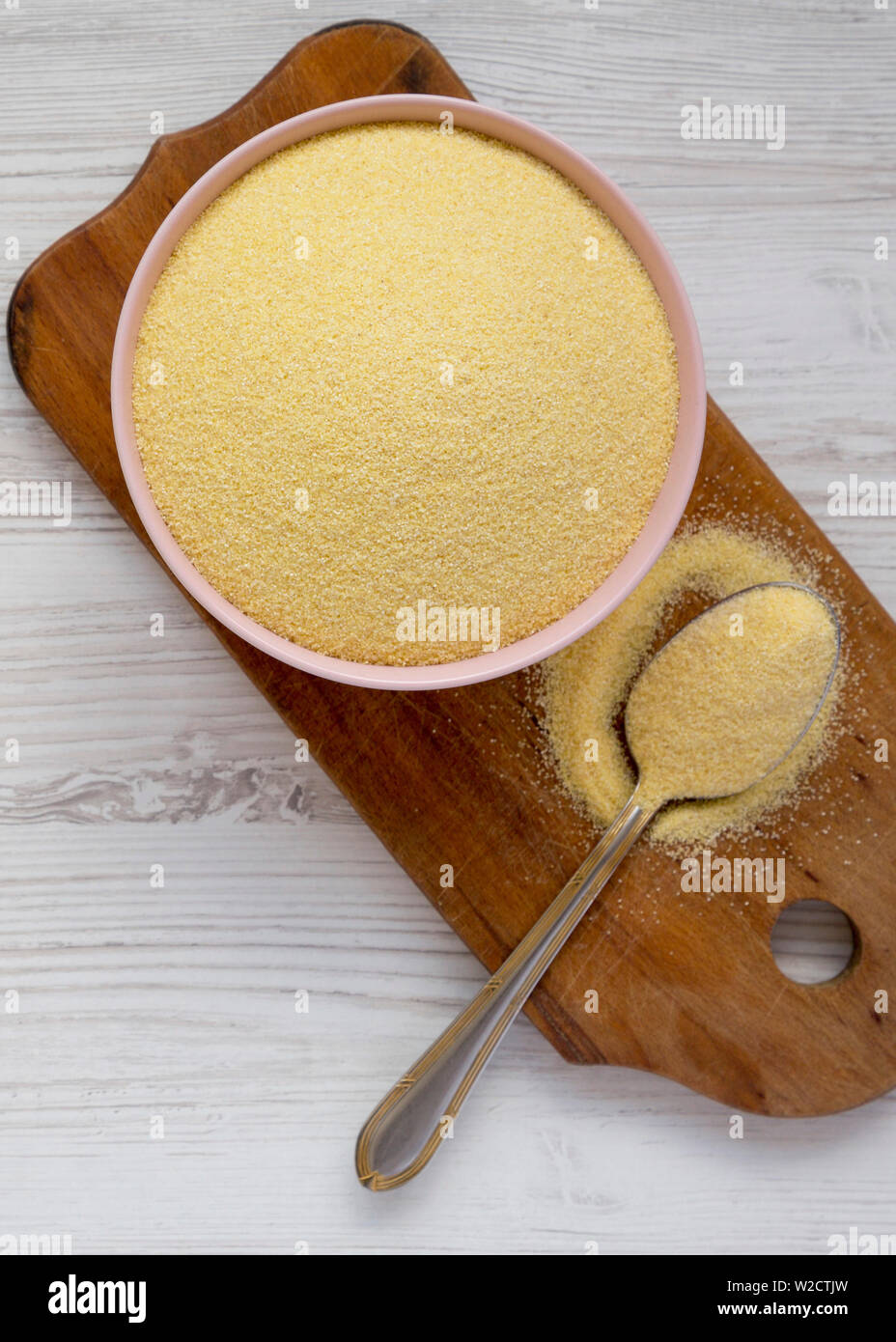 Overhead view, dry semolina durum flour in a pink bowl over white ...