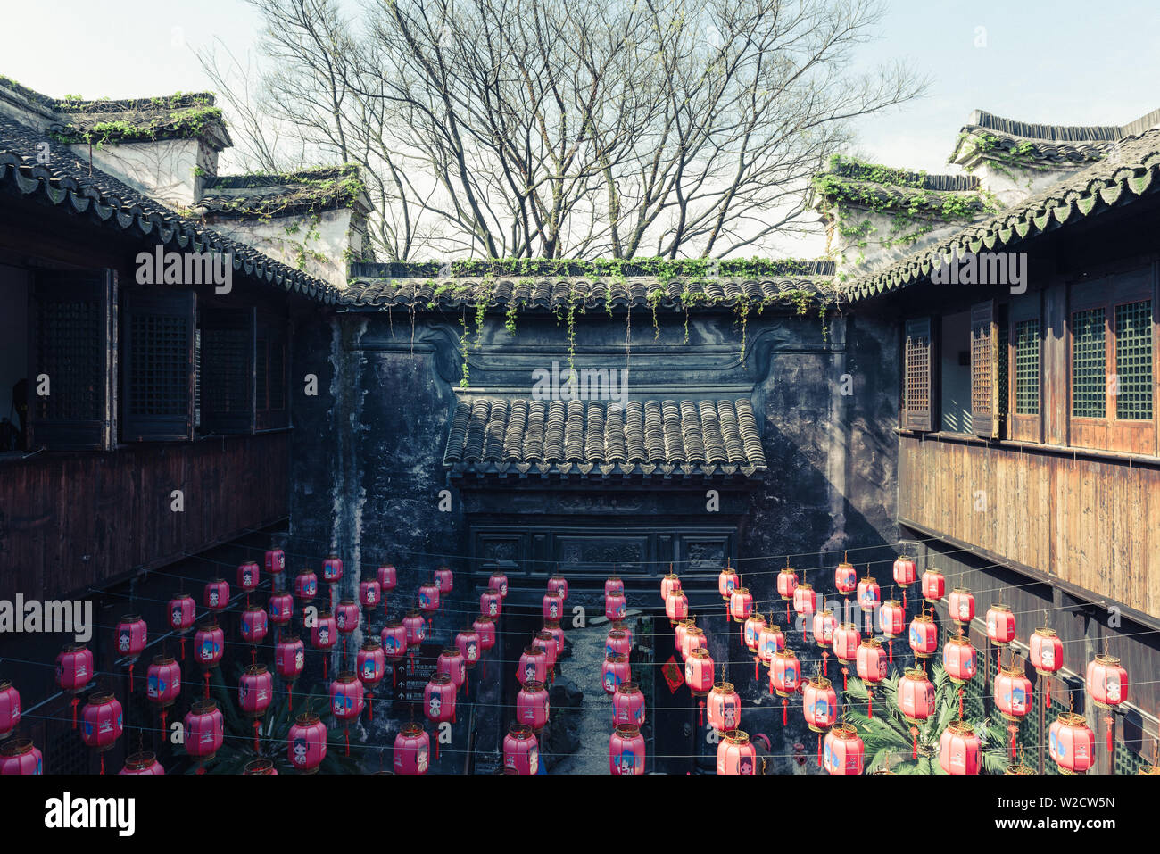Traditional Chinese houses with open windows and rooftops with black ...