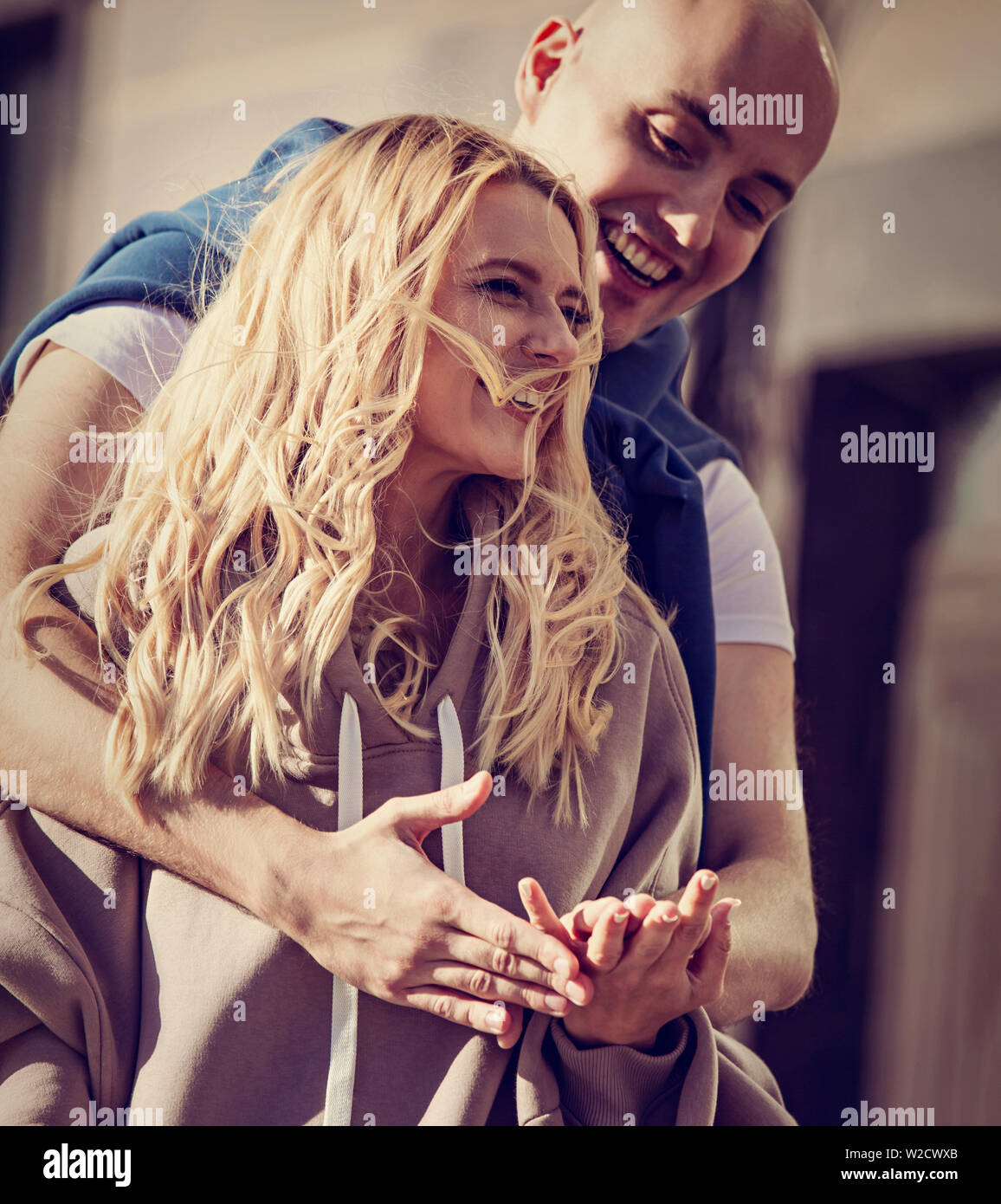 Beautiful laughing couple hugging with love and touching each other to ...