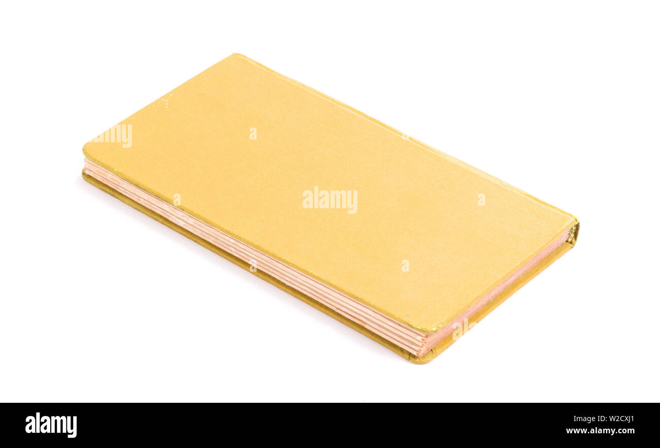 Closed old yellow book isolated on white background Stock Photo - Alamy