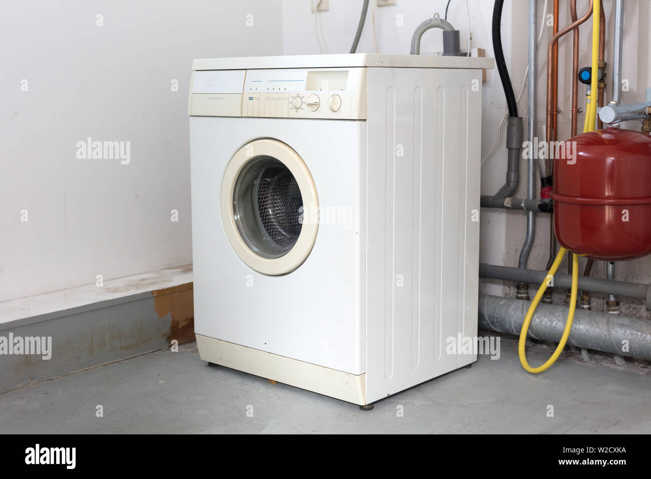 Old dirty washing machine on the attic, door closed Stock Photo - Alamy
