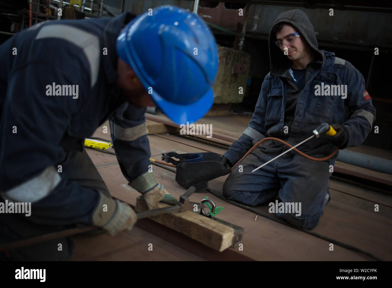Shipyard workers in Ferguson Marine shipyard on the River Clyde, in ...
