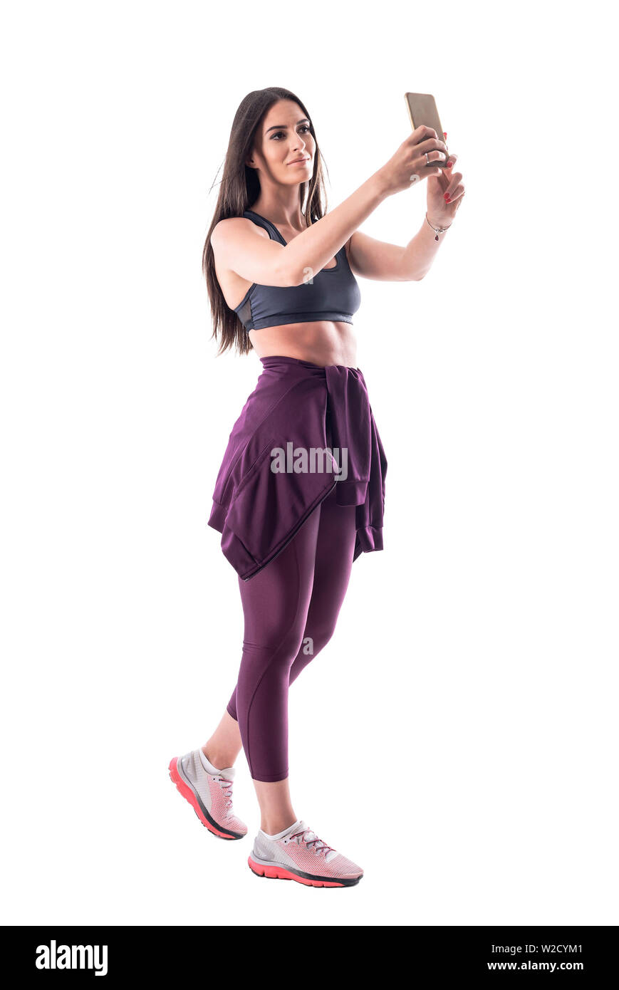 Happy relaxed young fit woman taking selfie with smartphone showing ...