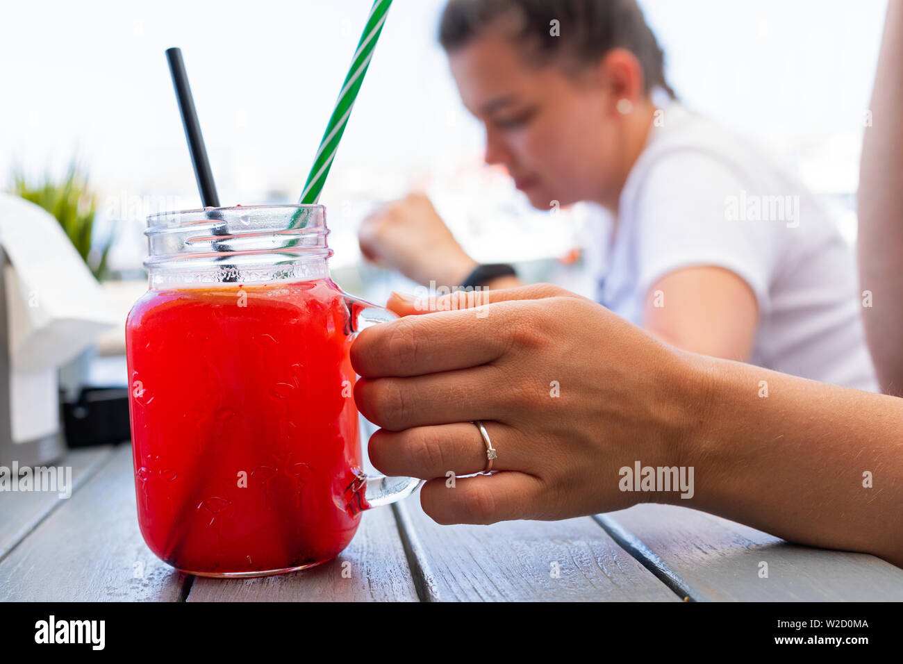 Holding a cold refreshing strawberry lemonade at a beach terrace on a ...