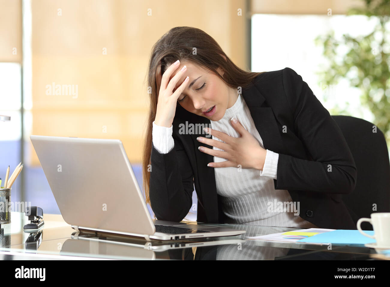 Worried businesswoman suffering an anxiety attack due to stressful life ...