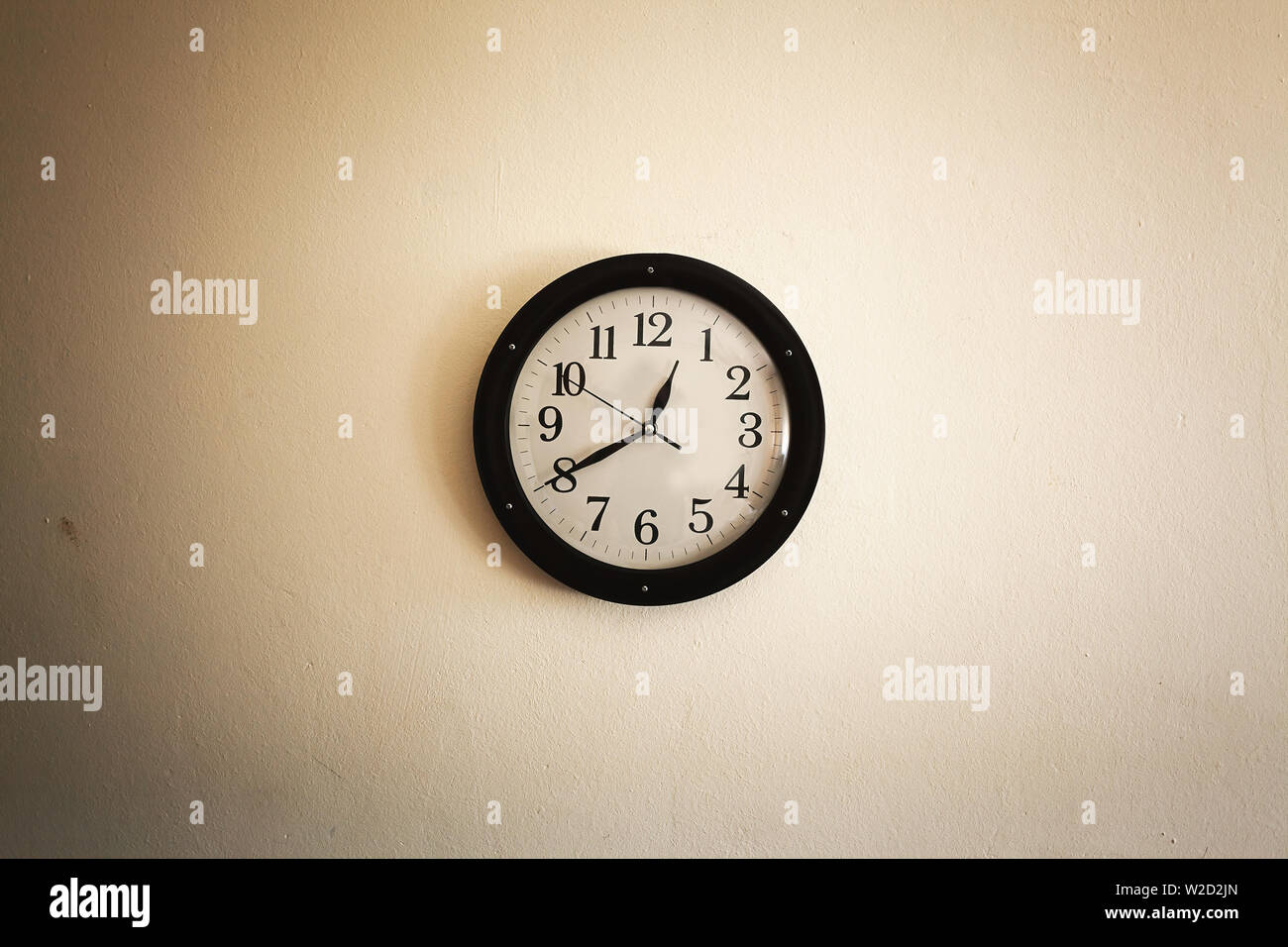 Old vintage style clock on old white wall Stock Photo - Alamy