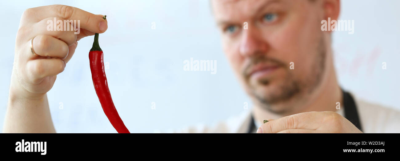 Professional Chef Showing Yellow Chili Pepper Stock Photo - Alamy