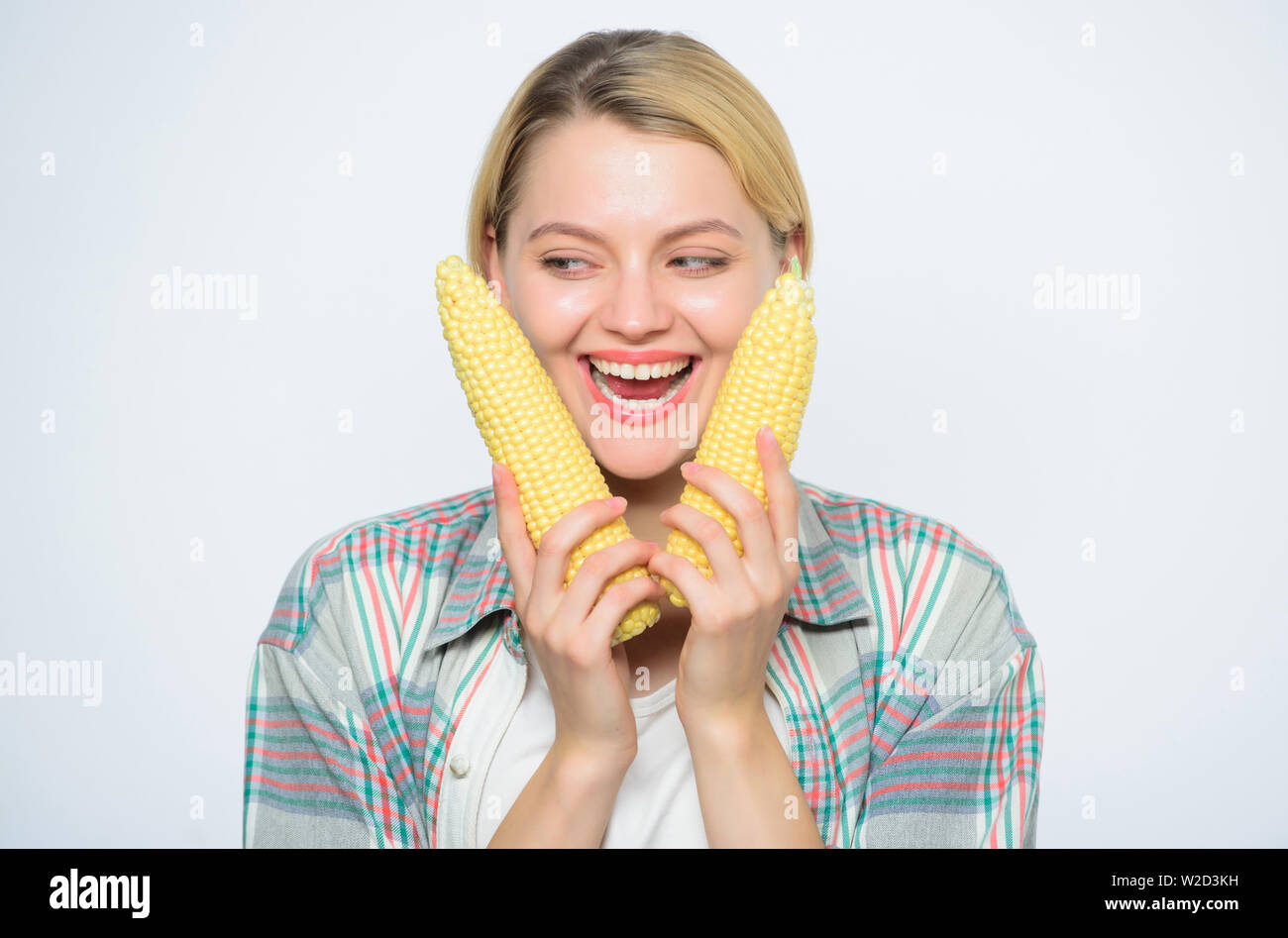 Corn harvest. Girl hold ripe corn. Food vegetarian and healthy natural ...