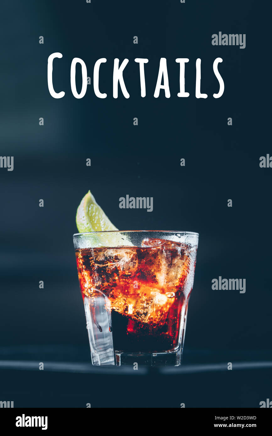 Cuba libre cocktail at the bar stand. Dark background. Vertical ...