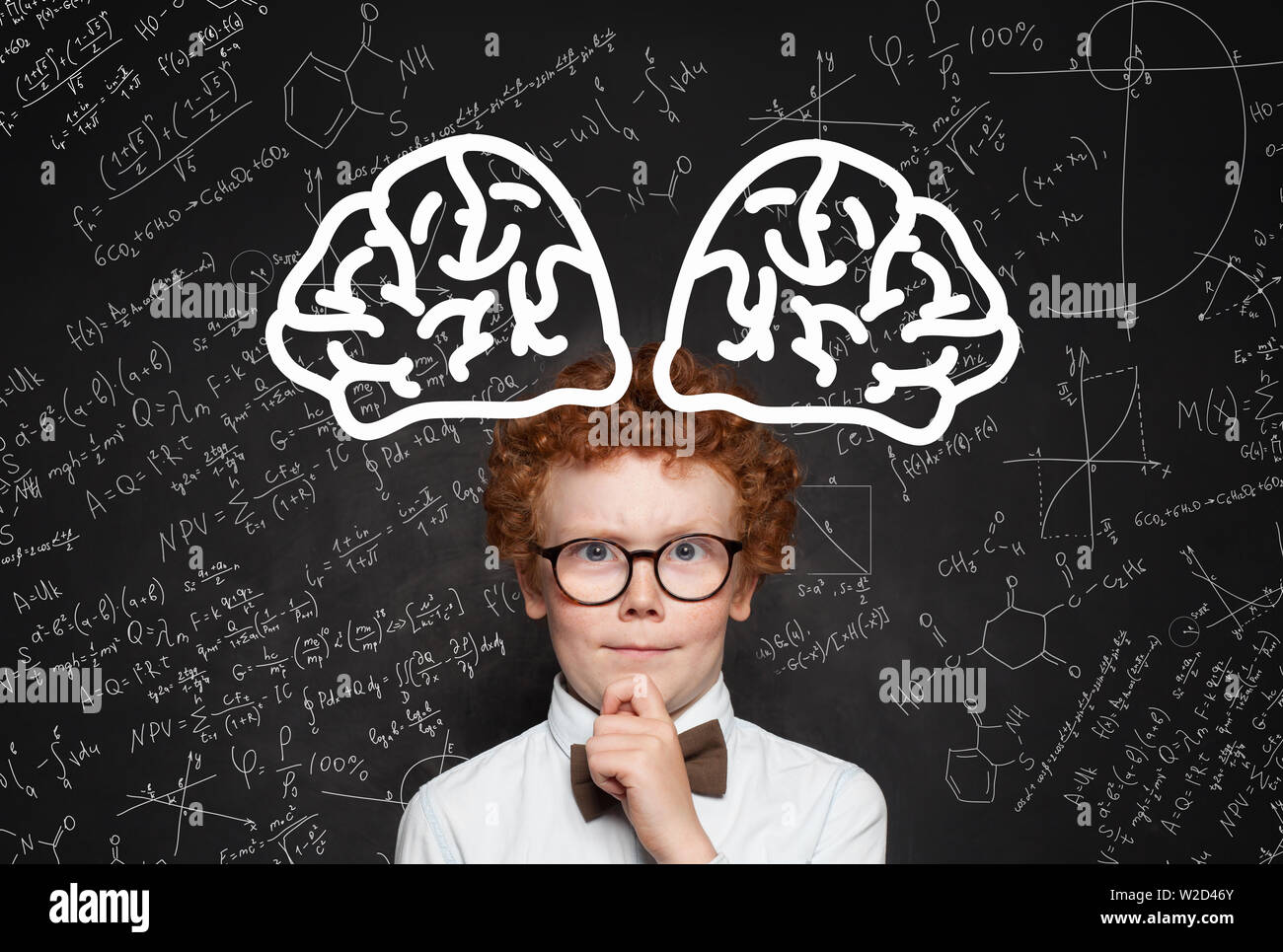 Thinking child genius in classroom portrait Stock Photo - Alamy
