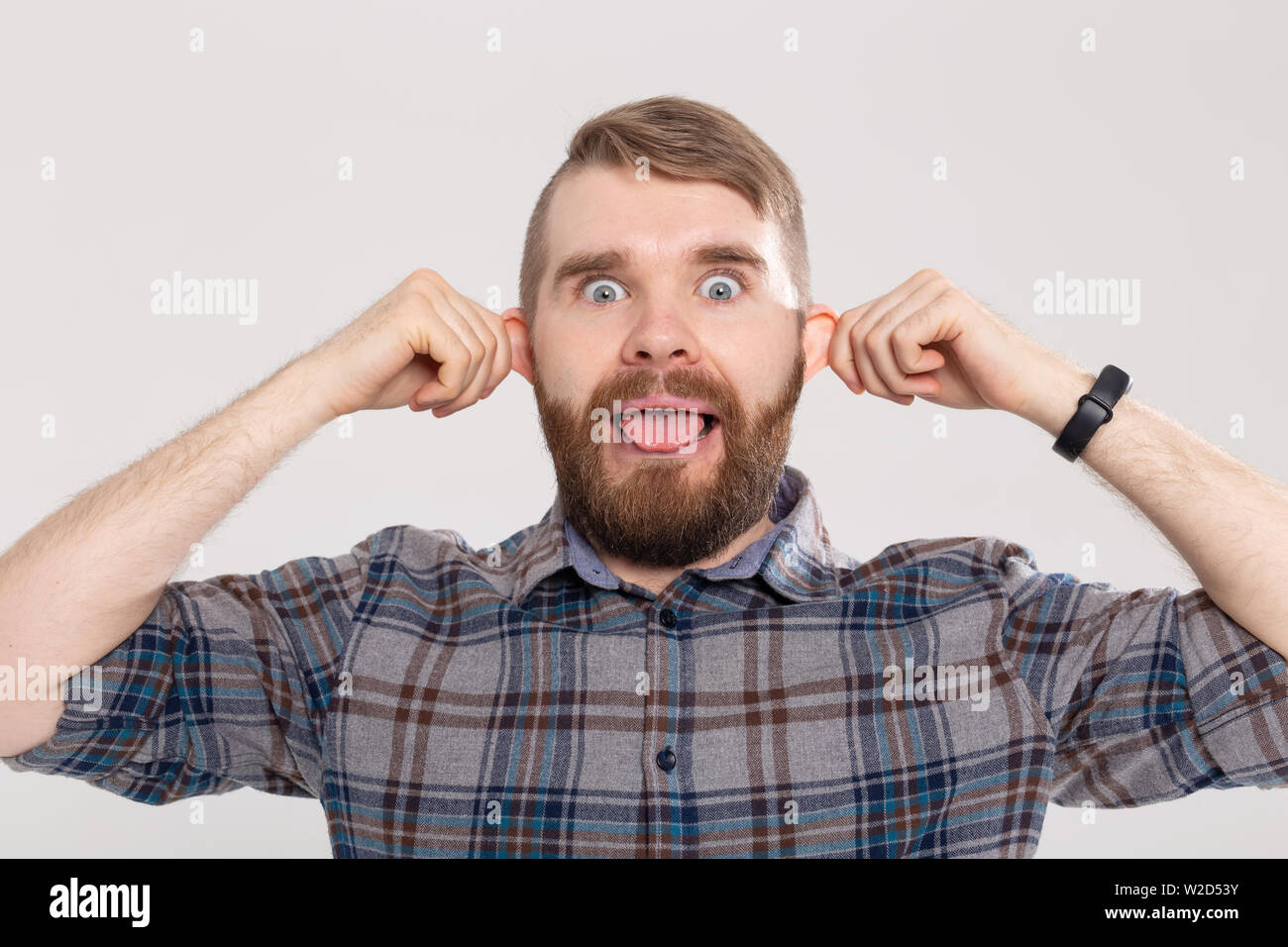 Funny crazy playful handsome man in plaid shirt making silly monkey ...