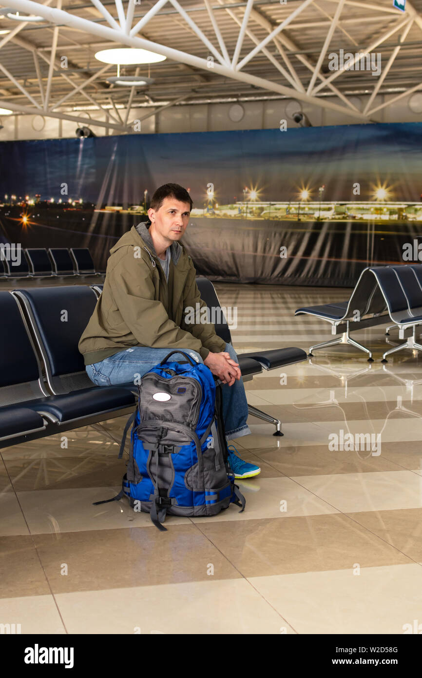 Man at the airport with baggage waiting for boarding his plane, the ...