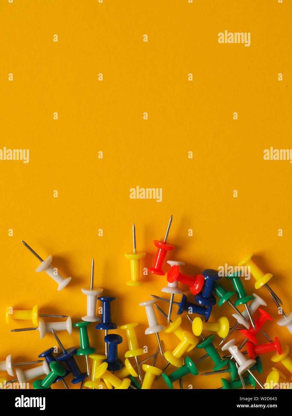 Colorful pushpins on a yellow background with space for text Stock ...