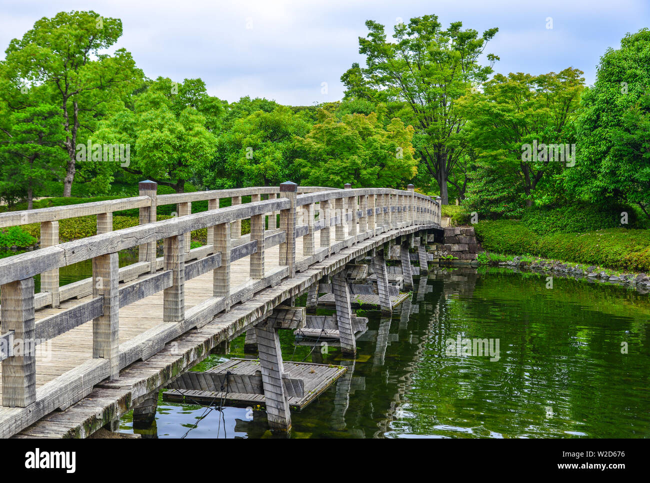 Traditional Japanese wooden bridge at summer day in botanical garden ...