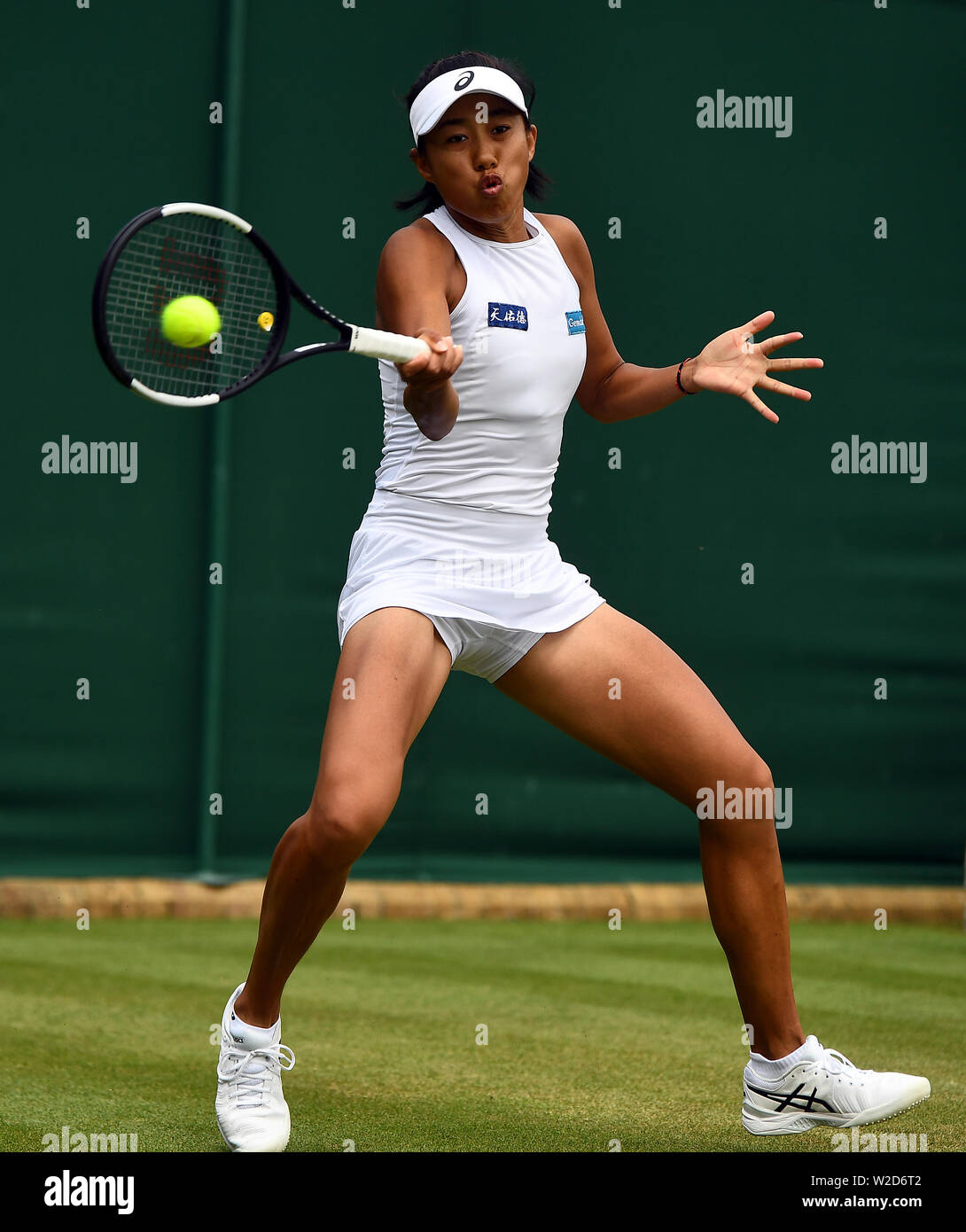 Shuai Zhang in action on day seven of the Wimbledon Championships at ...