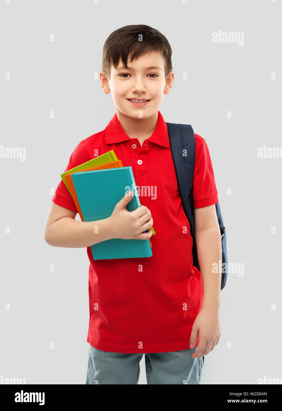 smiling schoolboy with books and school bag Stock Photo - Alamy
