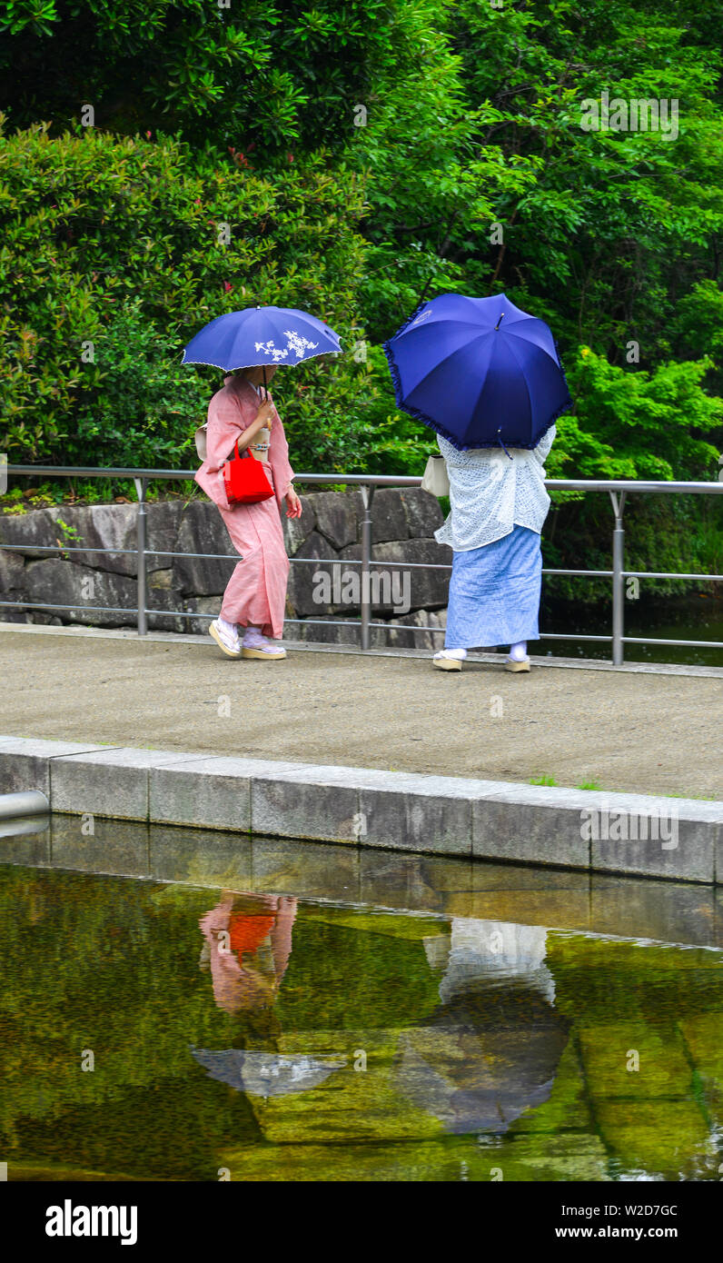 Asian traveler wearing traditional Japanese kimono walking in temple ...