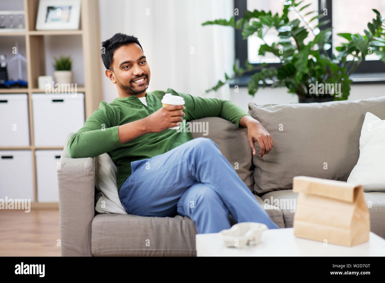happy indian man drinking takeaway coffee at home Stock Photo - Alamy