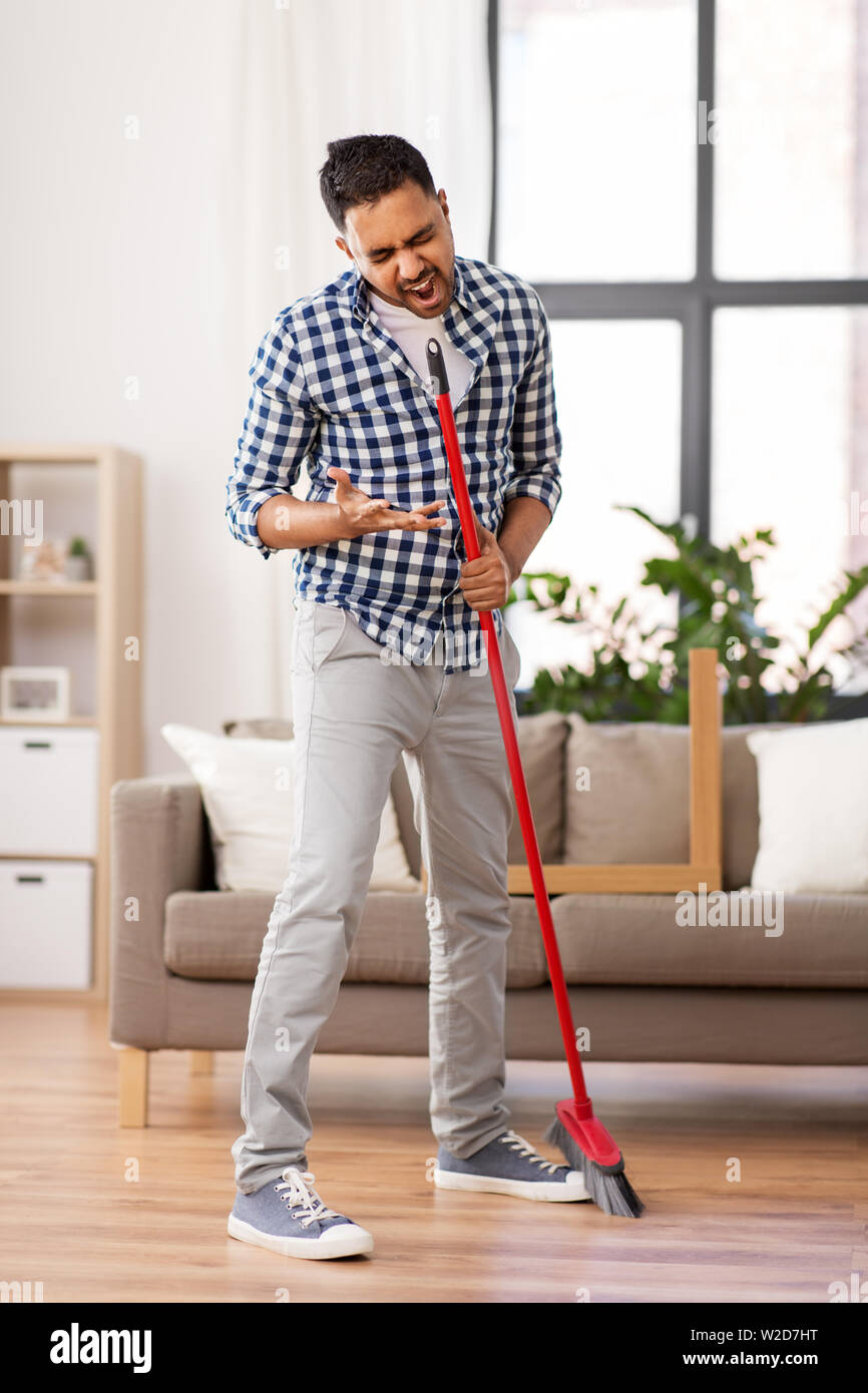 Man cleaning home broom hi-res stock photography and images - Alamy