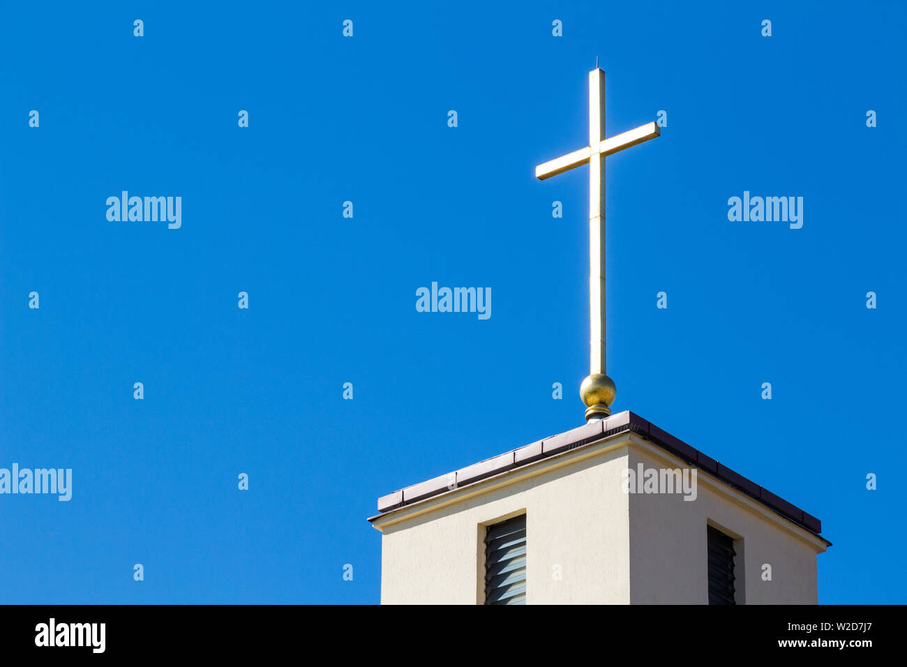 Shining cross on top of the steeple of Saint Stephen church against ...