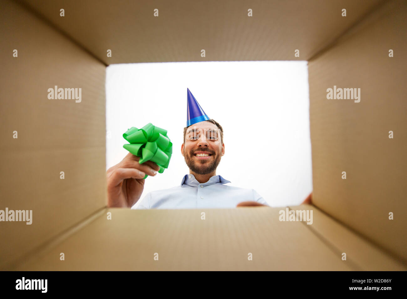 happy man opening parcel box or birthday gift Stock Photo - Alamy