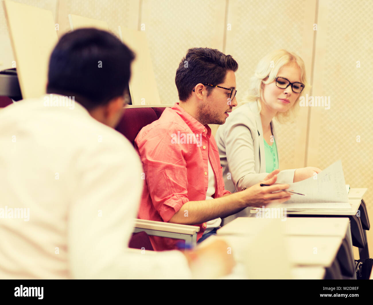 group of students with notebooks in lecture hall Stock Photo - Alamy