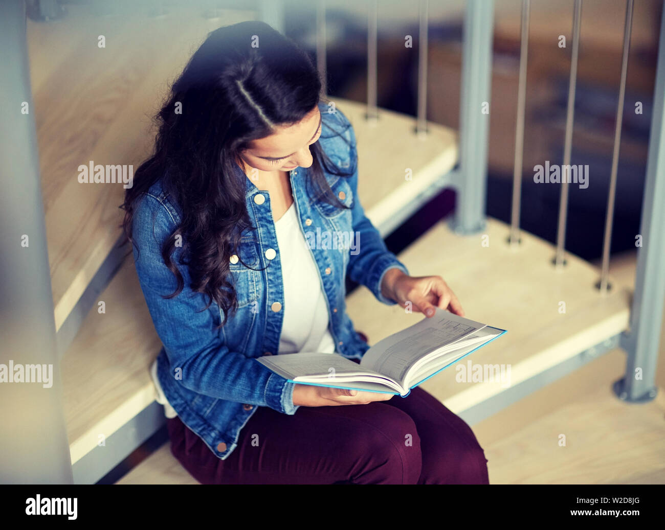 high school student girl reading book on stairs Stock Photo - Alamy
