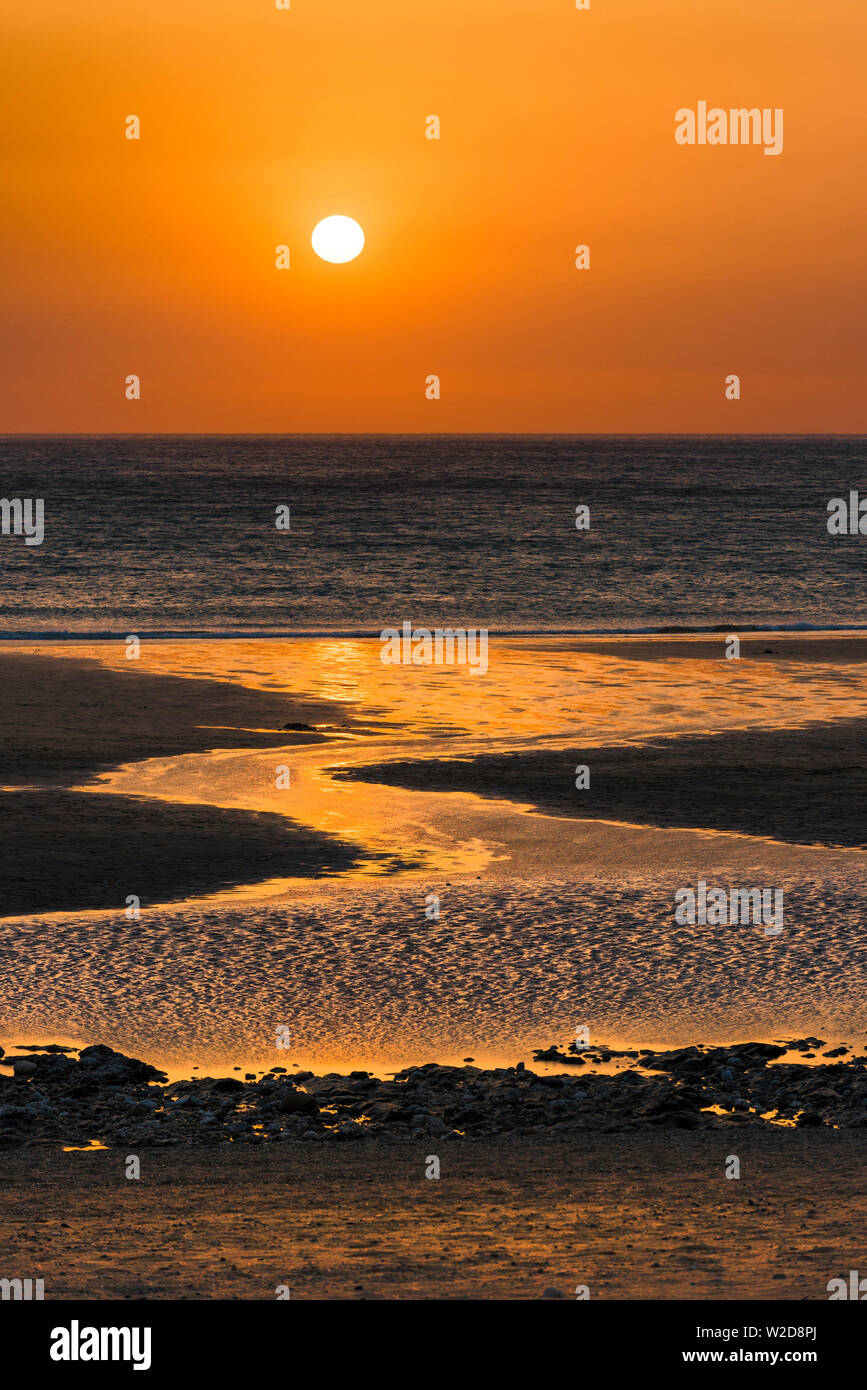 A beautiful intense sunset setting over Fistral Beach in Newquay in ...