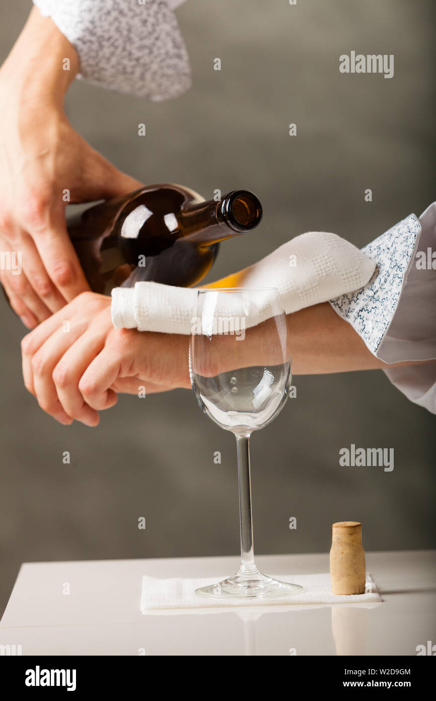Male waiter or butler serving pouring wine into glass Stock Photo - Alamy