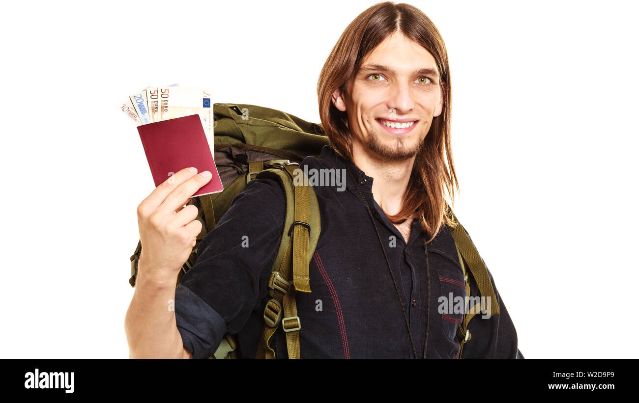 Man tourist backpacker holding passport full of money. Young guy hiker ...