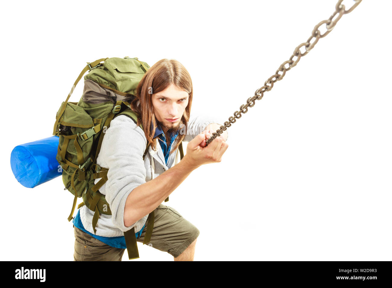 Backpacker mountaineer hiking climbing rock mountain. Young man ...