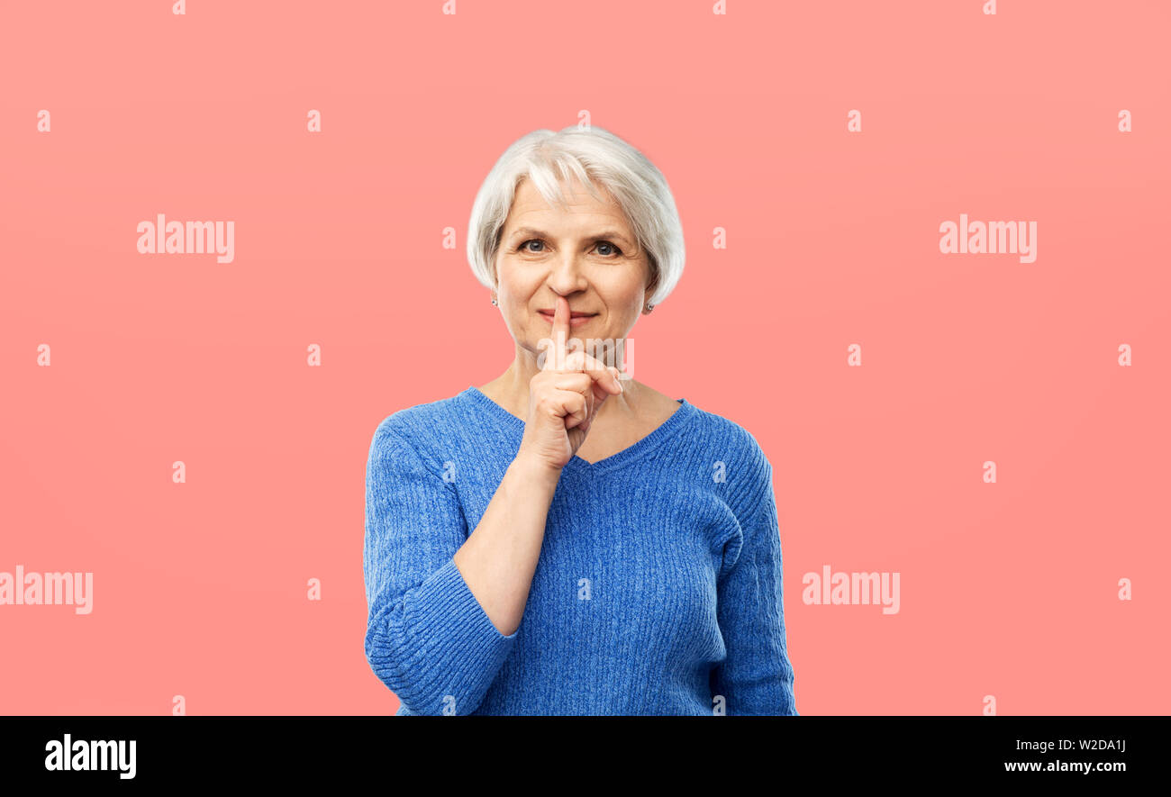 Woman shush smiling hi-res stock photography and images - Alamy
