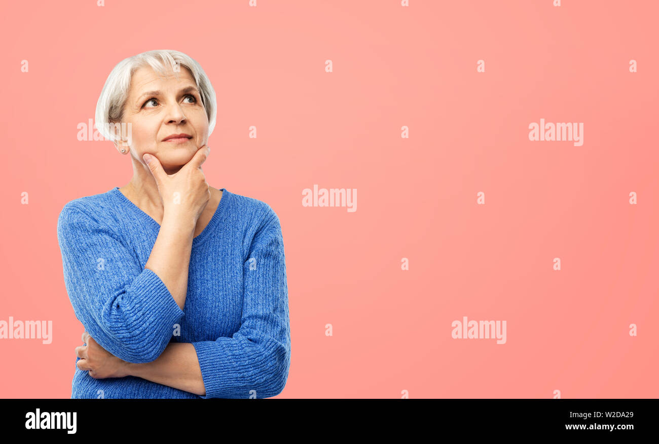portrait of senior woman in blue sweater thinking Stock Photo - Alamy