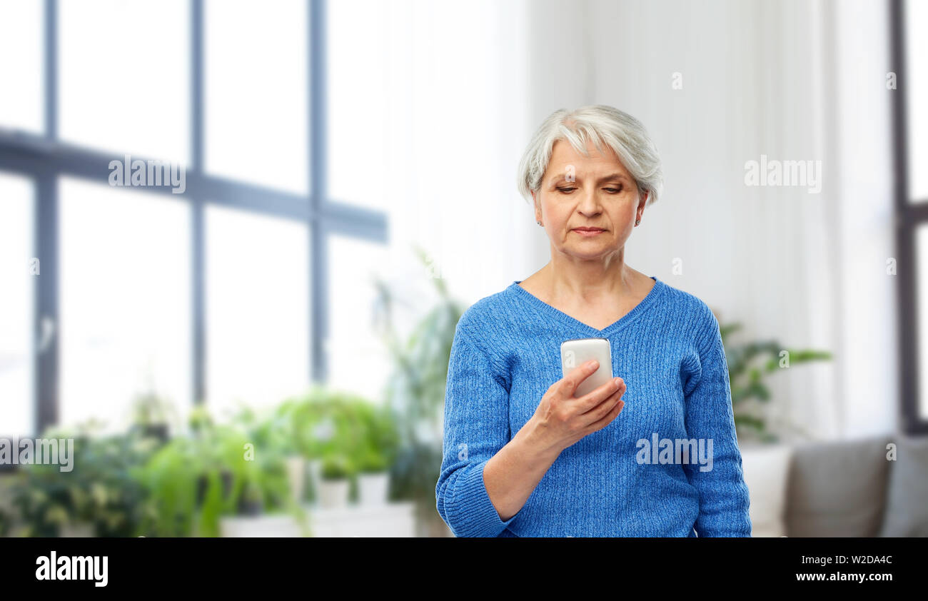 Serious older woman using hi-res stock photography and images - Alamy