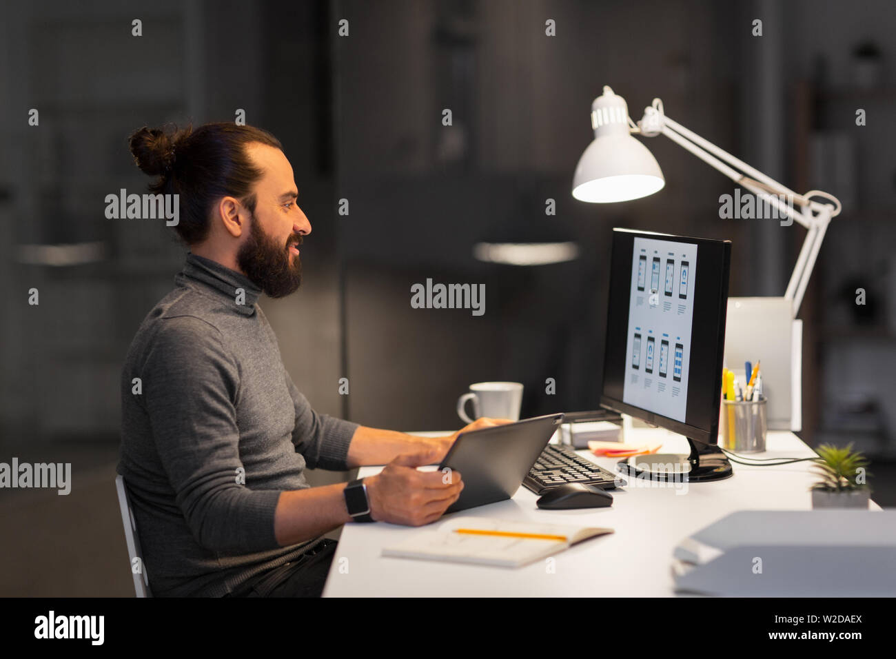 creative man with computer working at night office Stock Photo - Alamy