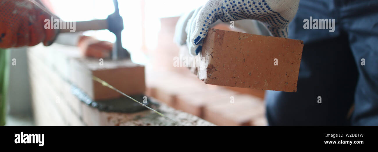 Male builder hand in gloves holding Stock Photo - Alamy