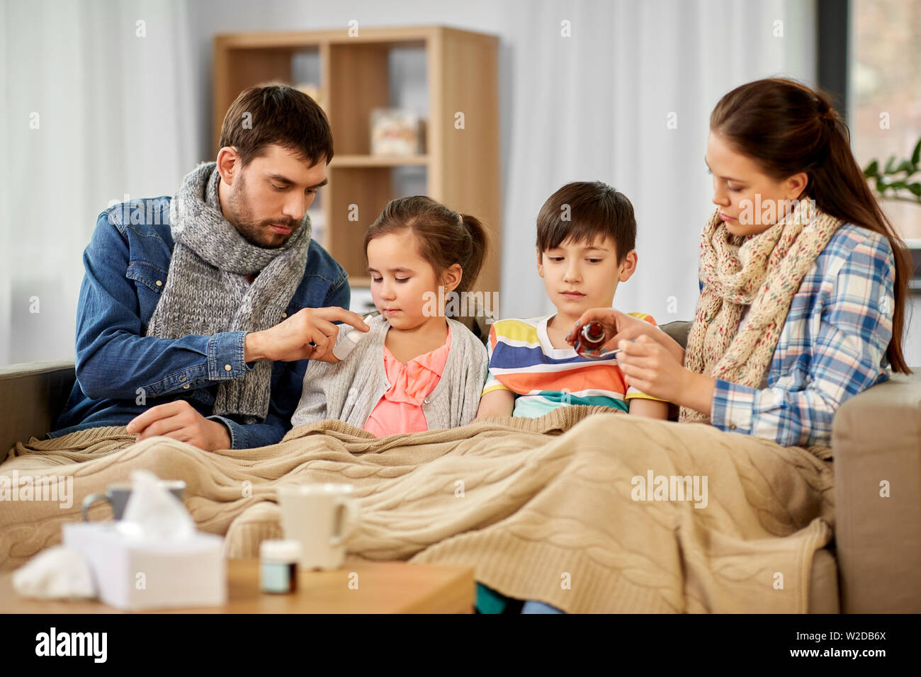 family with medicine treating ill children at home Stock Photo - Alamy