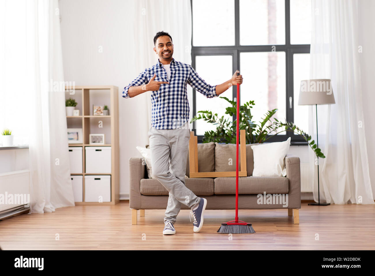 smiling indian man with broom cleaning at home Stock Photo - Alamy