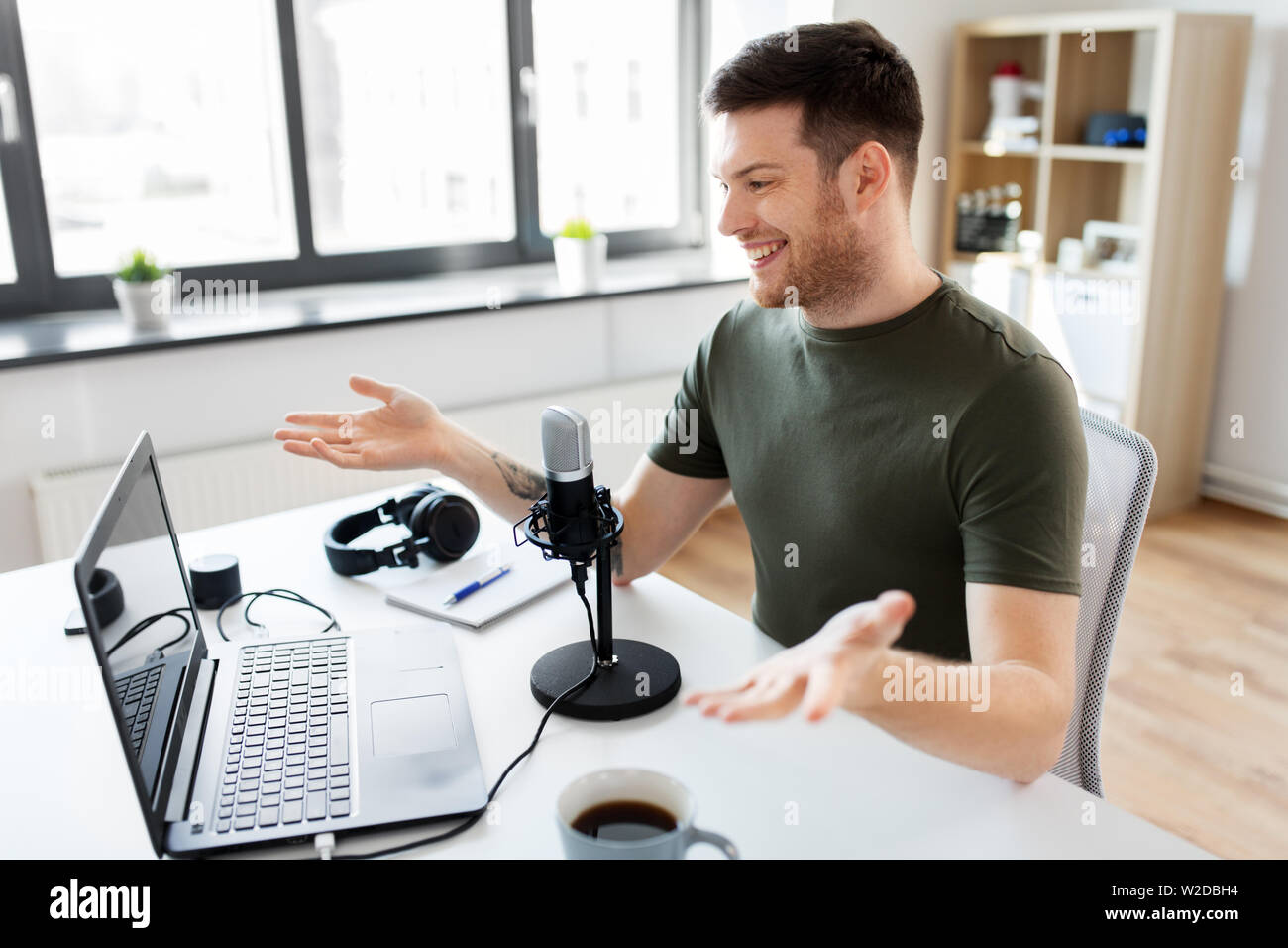 blogger with laptop and microphone audio blogging Stock Photo - Alamy