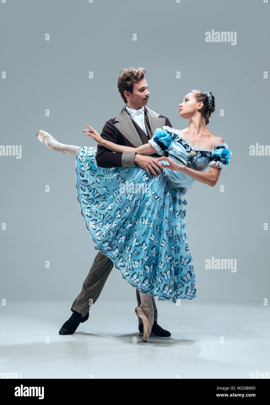 Straight look. Beautiful contemporary ballroom dancers isolated on grey ...