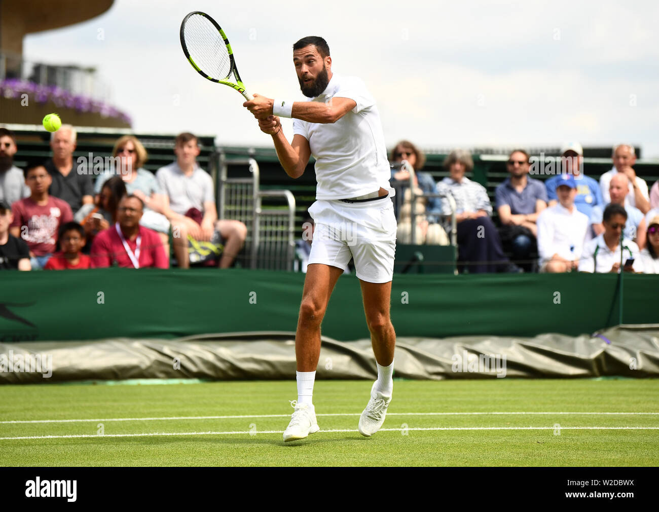 Benoit Paire in action against Roberto Bautista Agut on day seven of the Wimbledon Championships ...