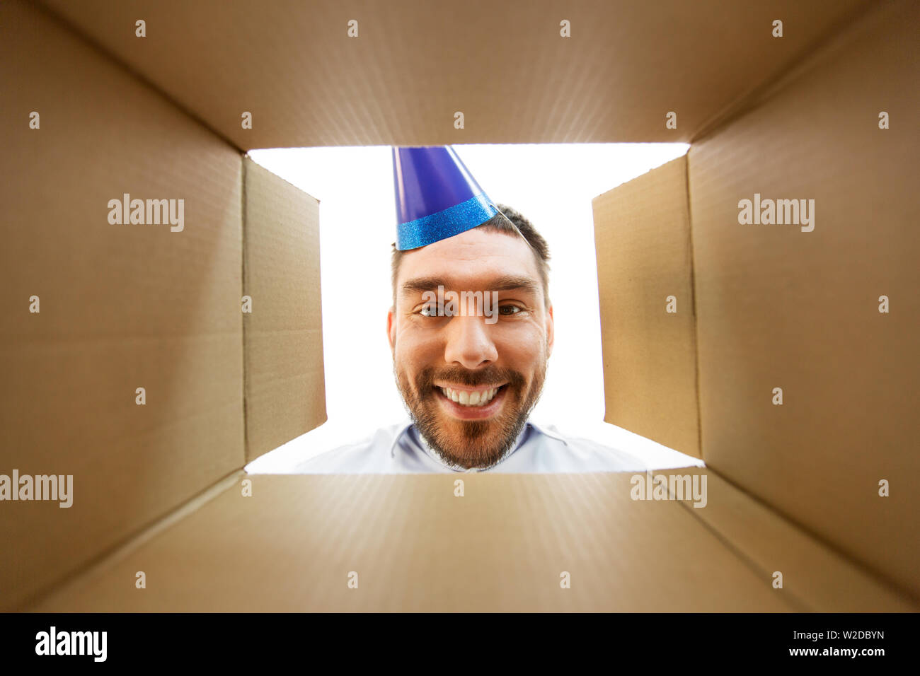 happy man opening parcel box or birthday gift Stock Photo - Alamy
