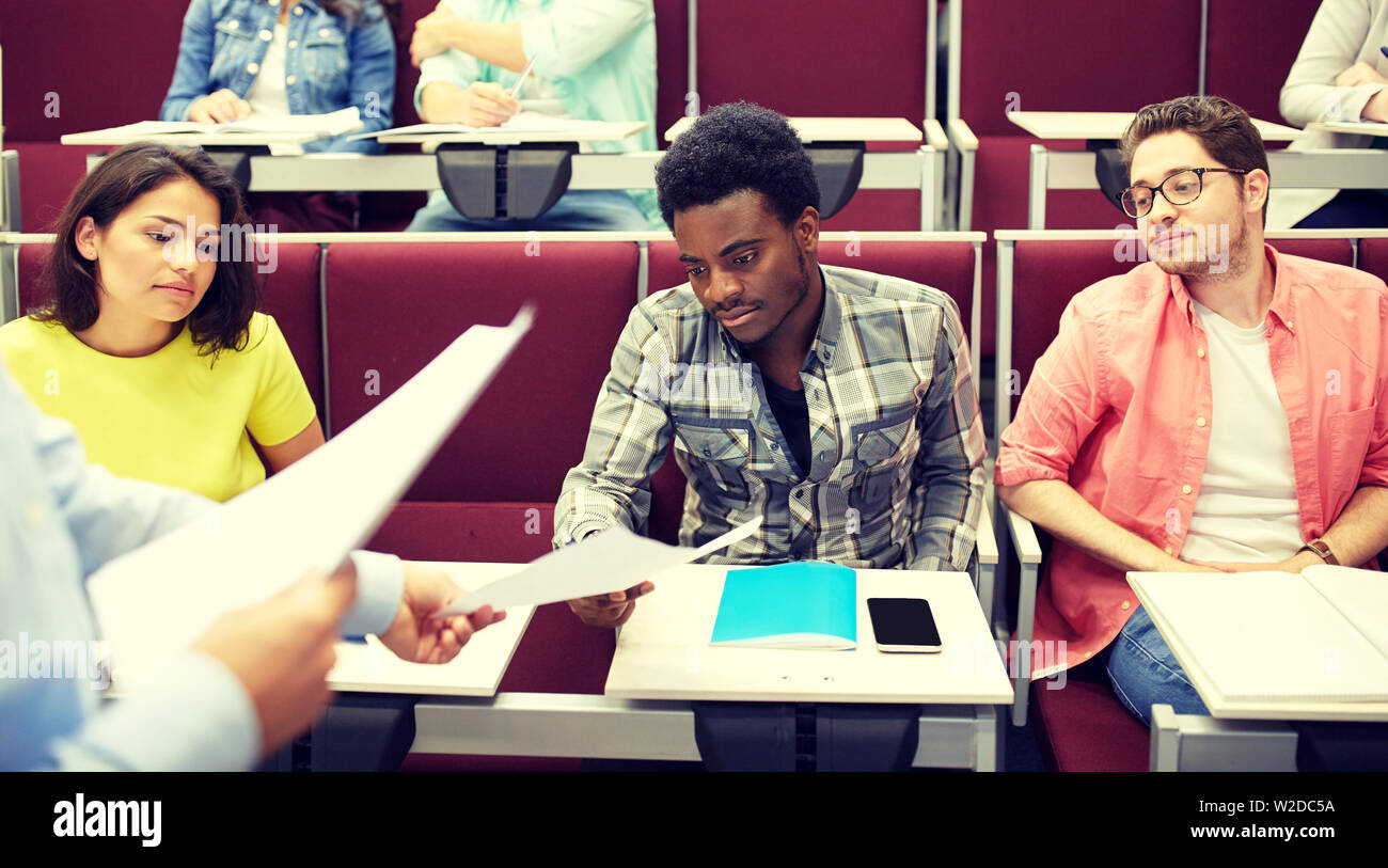 teacher giving tests to students at lecture Stock Photo - Alamy