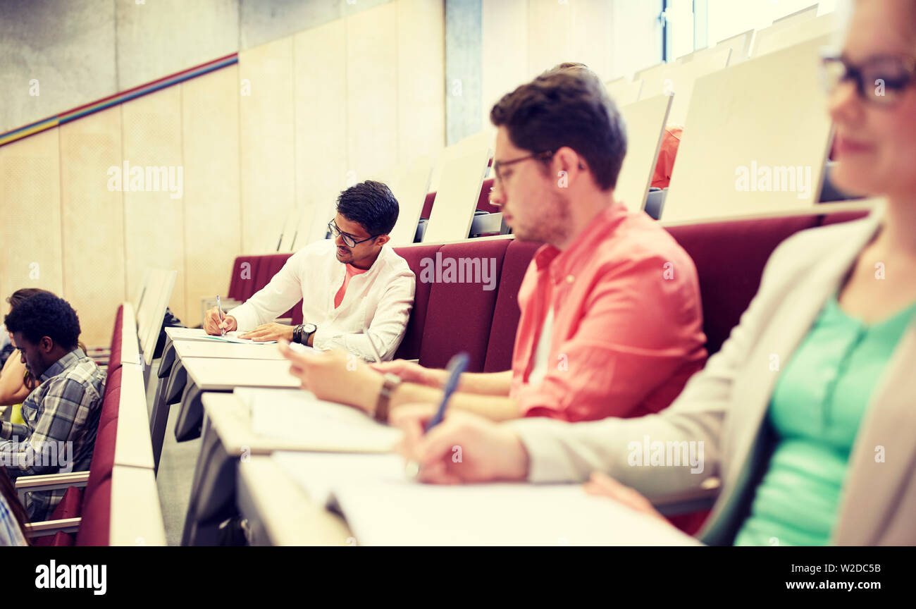 group of students with notebooks in lecture hall Stock Photo - Alamy
