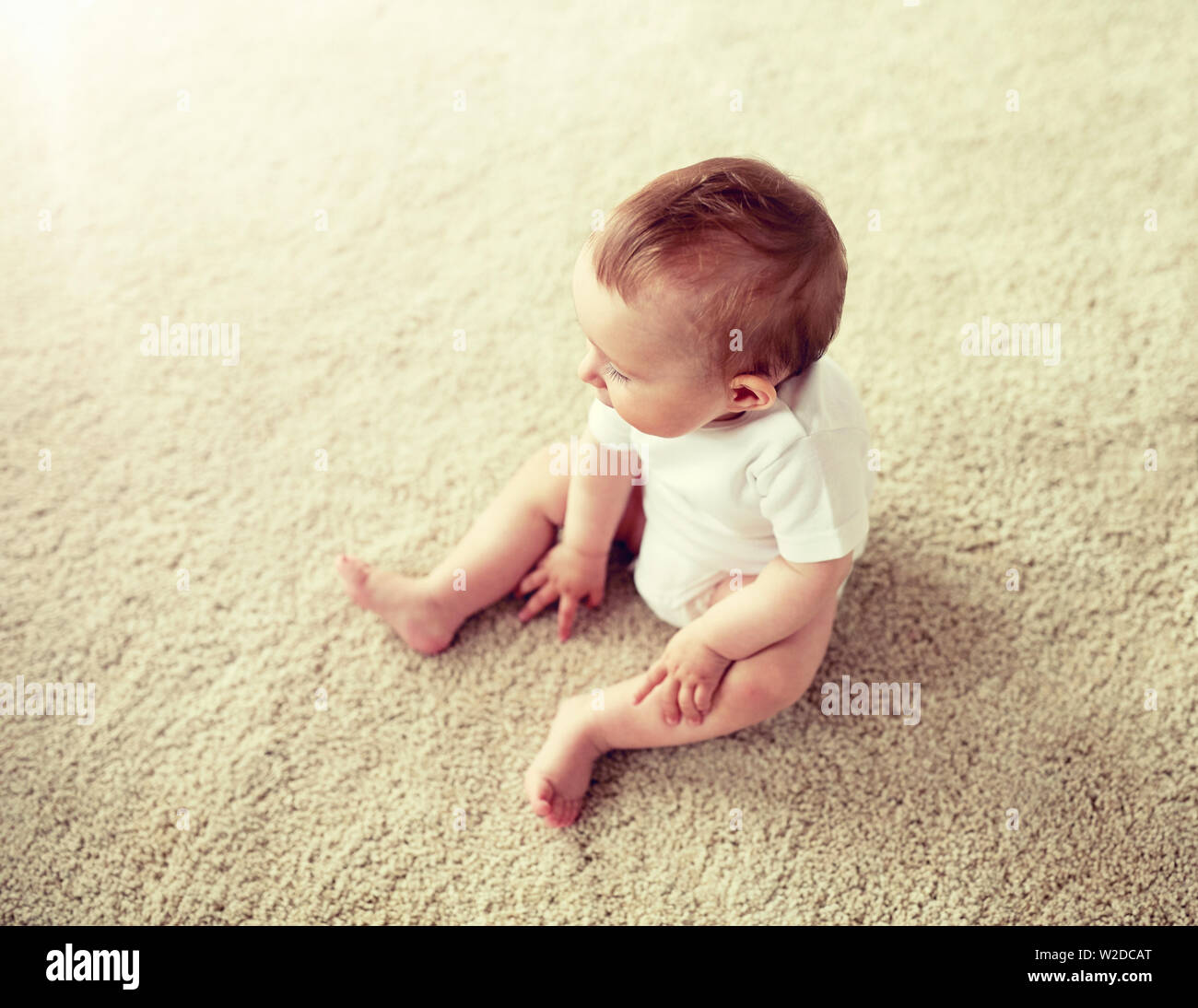 happy baby boy or girl sitting on floor at home Stock Photo - Alamy
